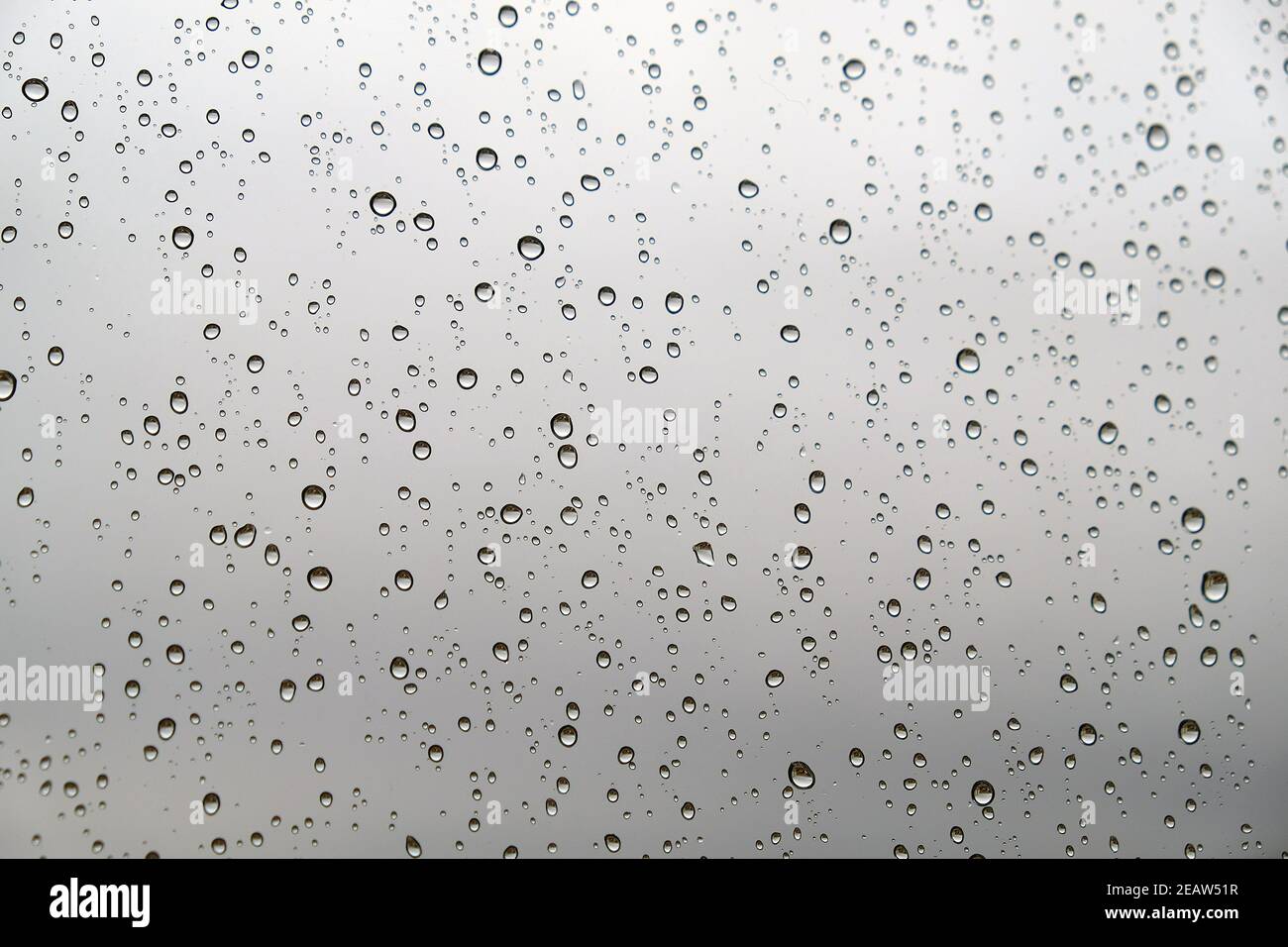 water droplets on glass and view of the landscape, droplets on close-up ...