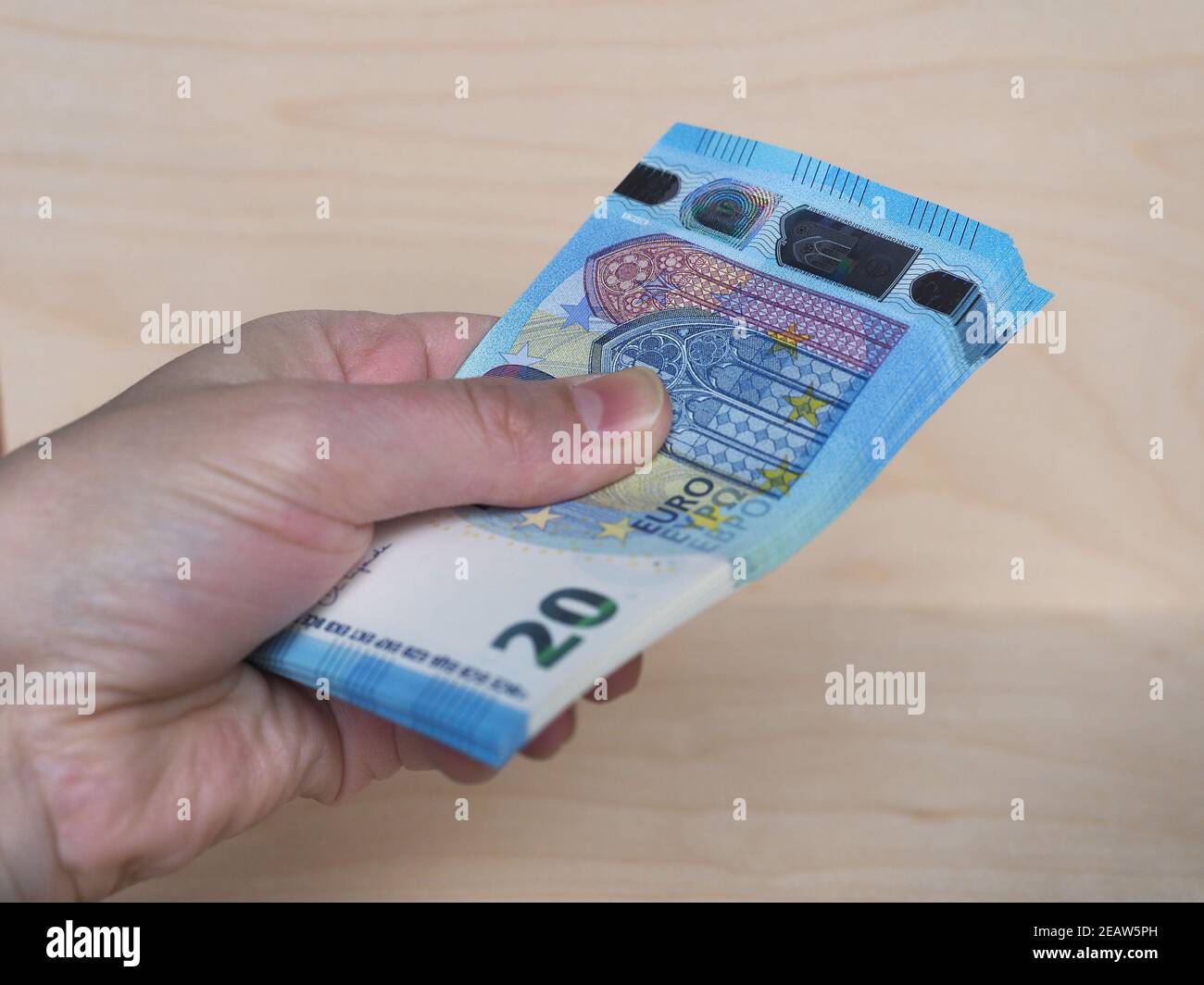 Hand holding Euro notes, European Union Stock Photo - Alamy