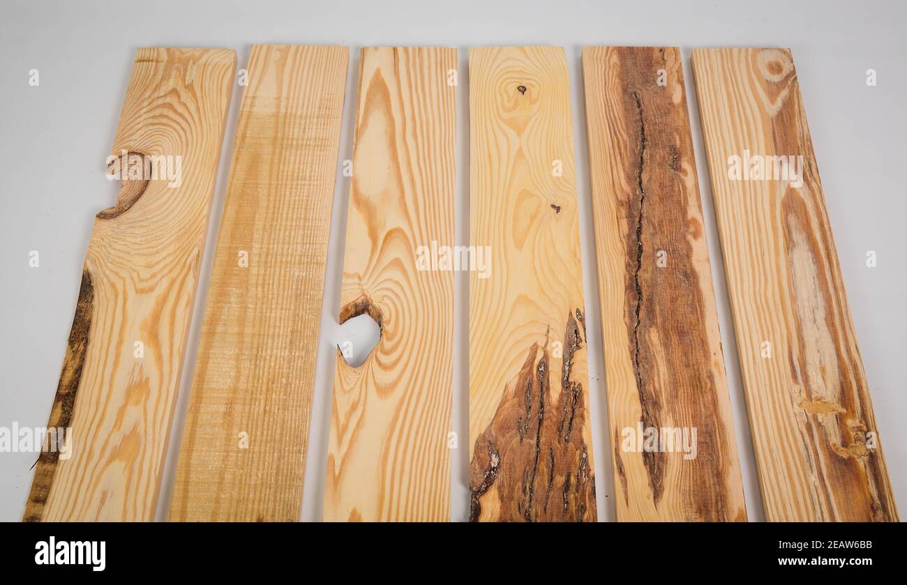 Unfinished raw pine lumber with light and dark color variation on a ...