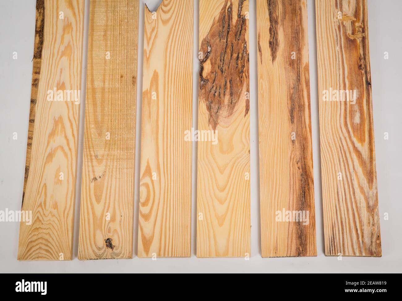 Unfinished raw pine lumber with light and dark color variation on a ...