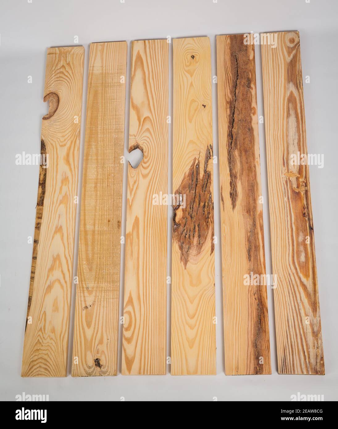 Unfinished raw pine lumber with light and dark color variation on a ...