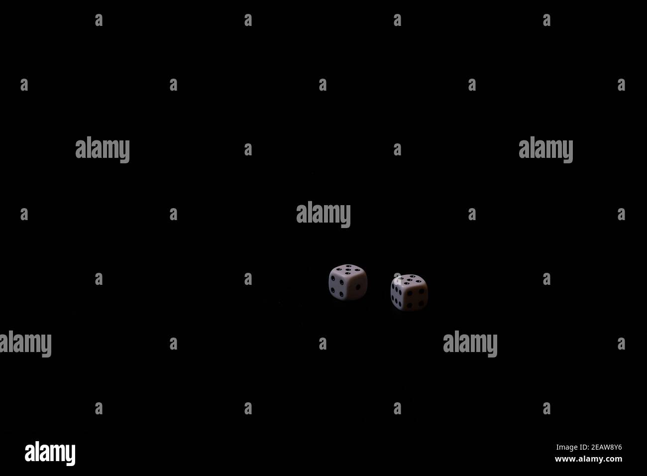 Two dice on black background Stock Photo - Alamy