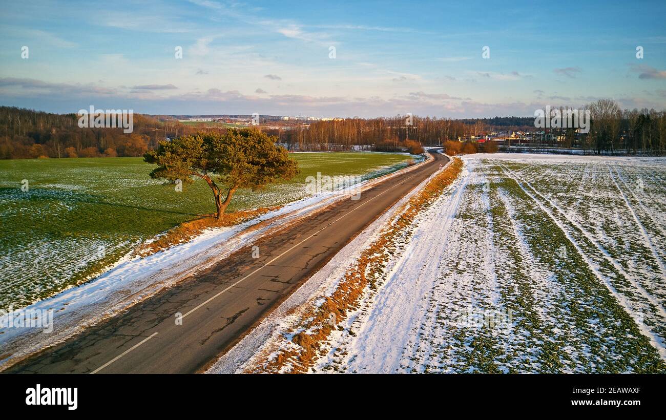 Winter Agricultural field under snow. Countryside road Aerial view ...