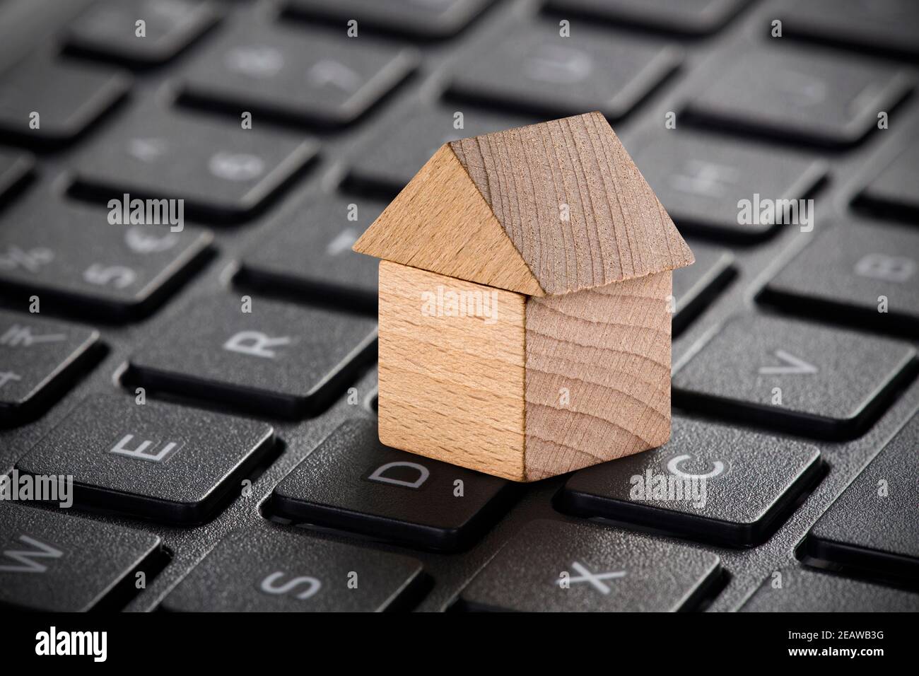 Small wooden house on laptop keyboard Stock Photo - Alamy