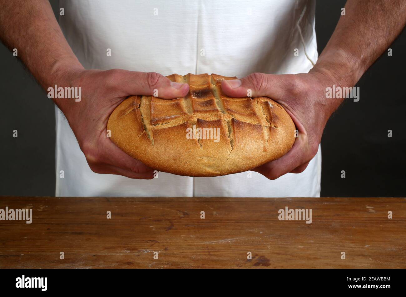 Breaking of a fresh loaf of Eucharistic bread Stock Photo - Alamy