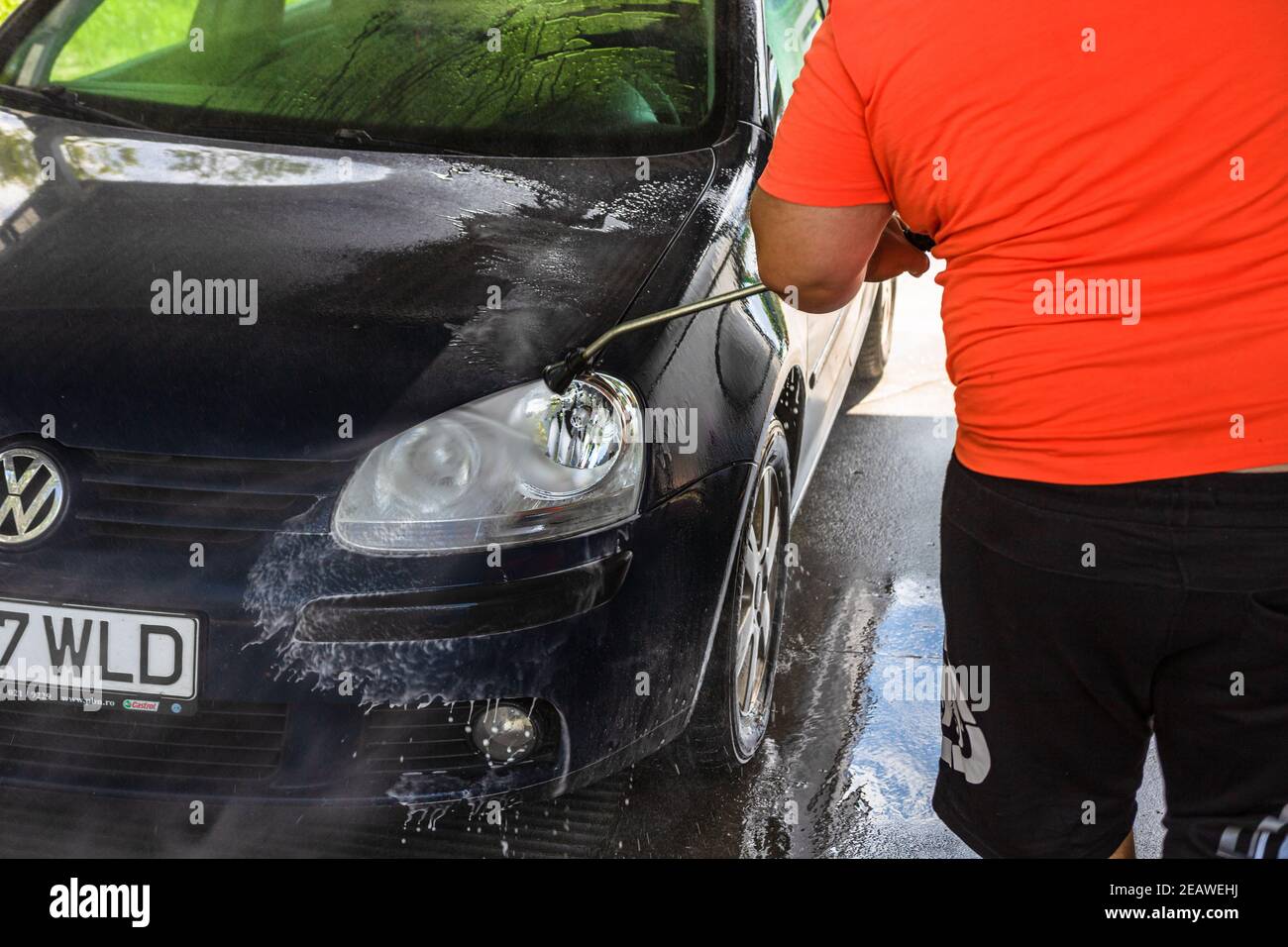 Washing and cleaning car in self service car wash station. Car washing ...