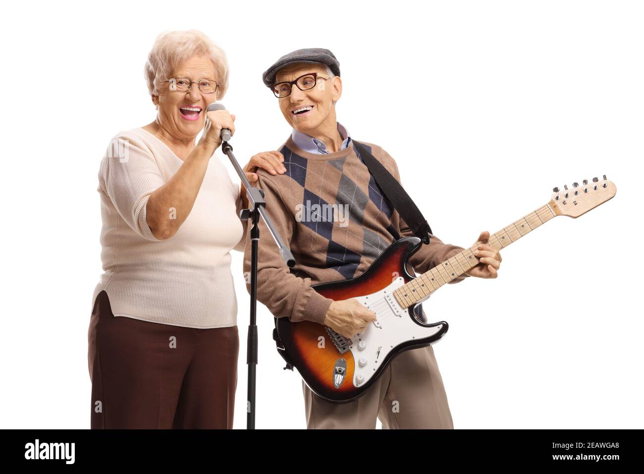 Elderly woman with a microphone and an elderly gentleman playing a ... Elderly woman with a microphone and an elderly gentleman playing a ...