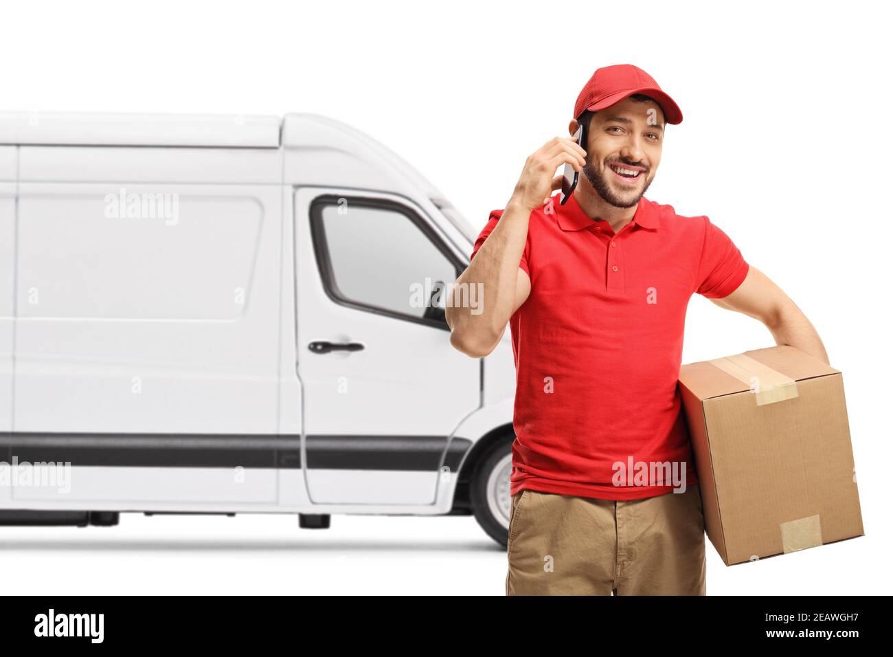 Delivery man with a van using a mobile phone and holding a package ...
