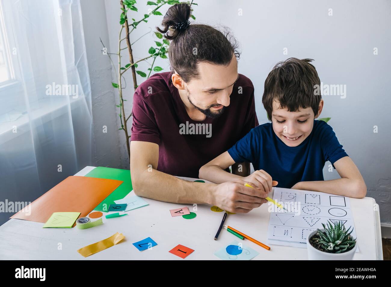Autistic boy during therapy at home with his father with learning and ...