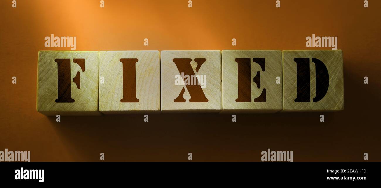 Fixed word written on wood block. Business accounting financial concept ...