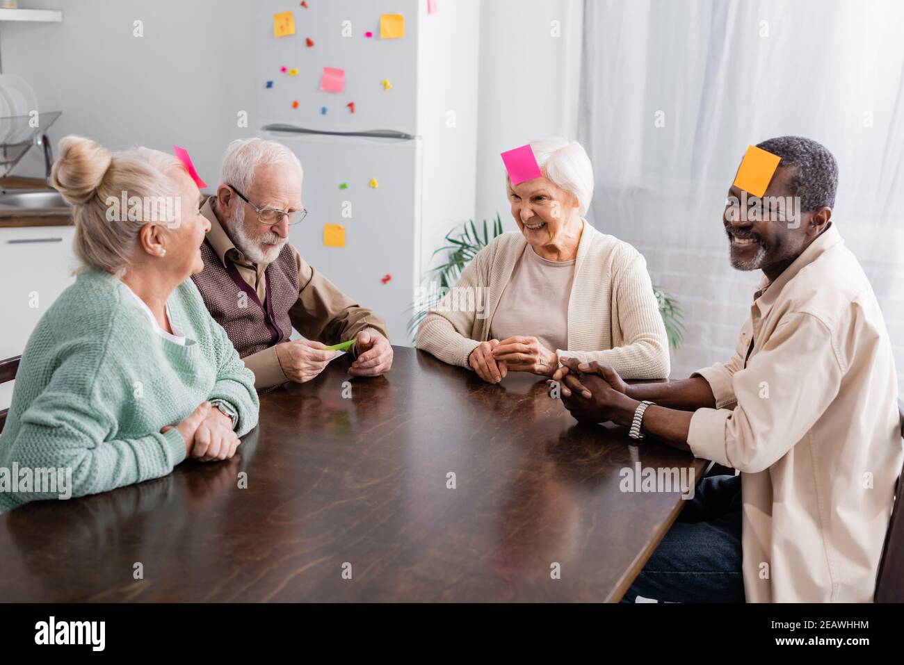 smiling multicultural senior friends with colorful sticky notes on ...
