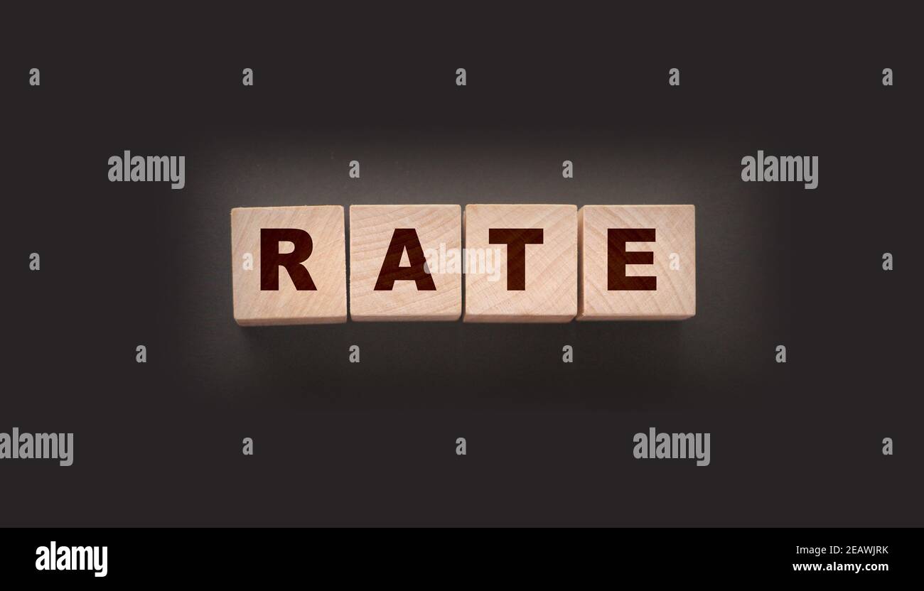Rate word concept written on wooden cubes blocks lying on a black ...