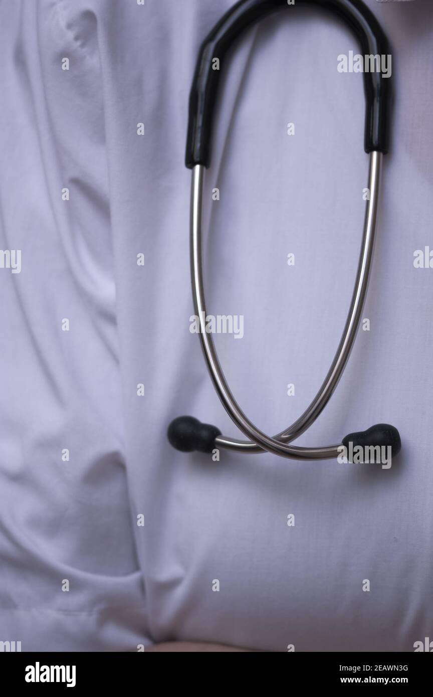Close-up of the chest of a doctor wearing a hanging stethoscope for use ...