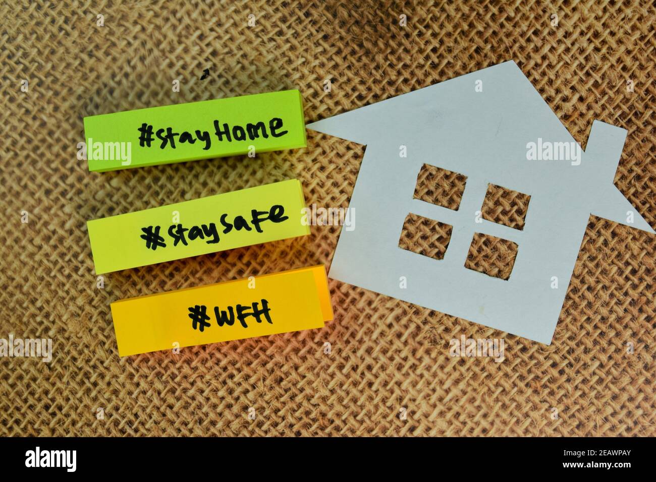 Stay Home, Stay Safe, and WFH write on sticky notes isolated on Wooden ...