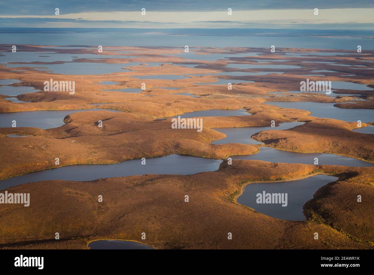 Aerial fall view of arctic tundra and water bodies, with the Inuvik ...
