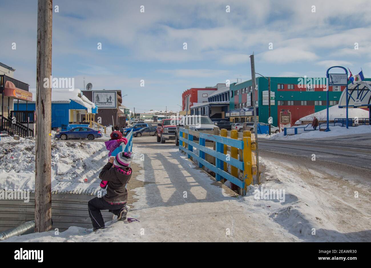 Children playing along main street in downtown Inuvik in winter ...