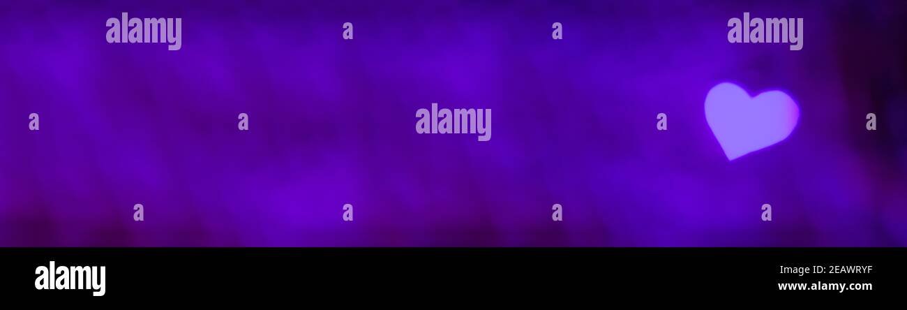 Banner of purple and violet lights makes hear shape bokeh at the right ...