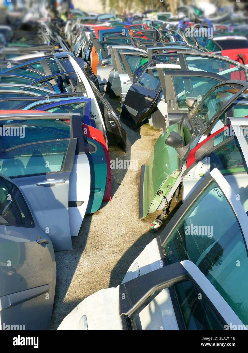 Vertical shot of colorful broken car doors for spare use abandoned ...