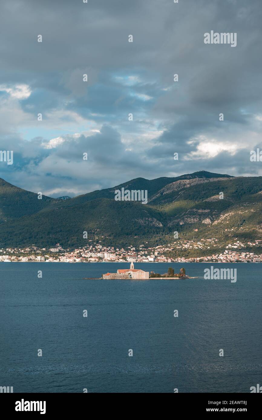 Vertical shot of a medieval church on an island in the sea in ...