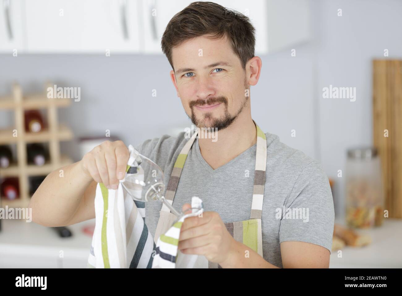 young man drying dishes Stock Photo - Alamy