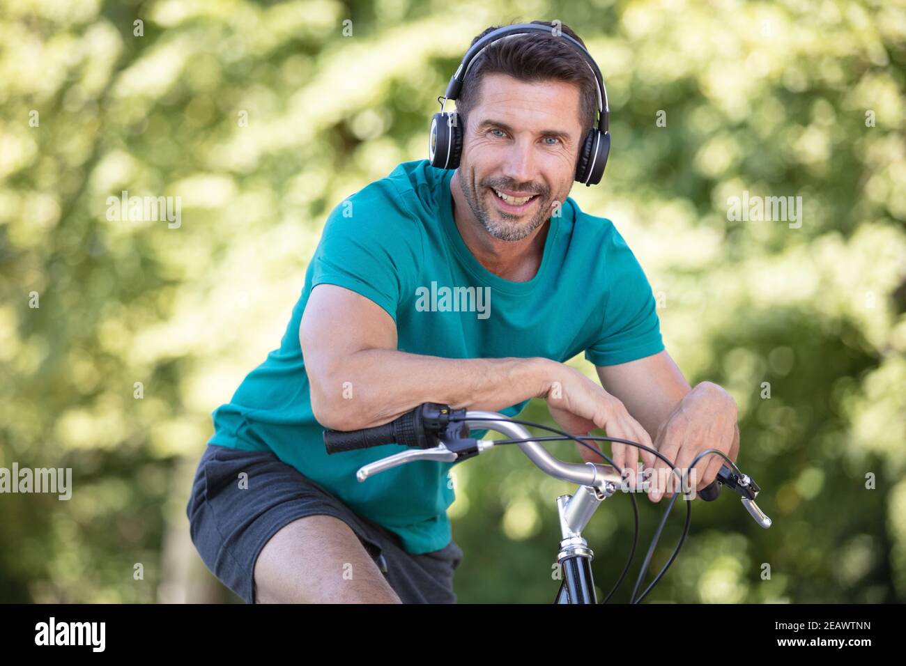 man listening to music a after a bike ride Stock Photo - Alamy