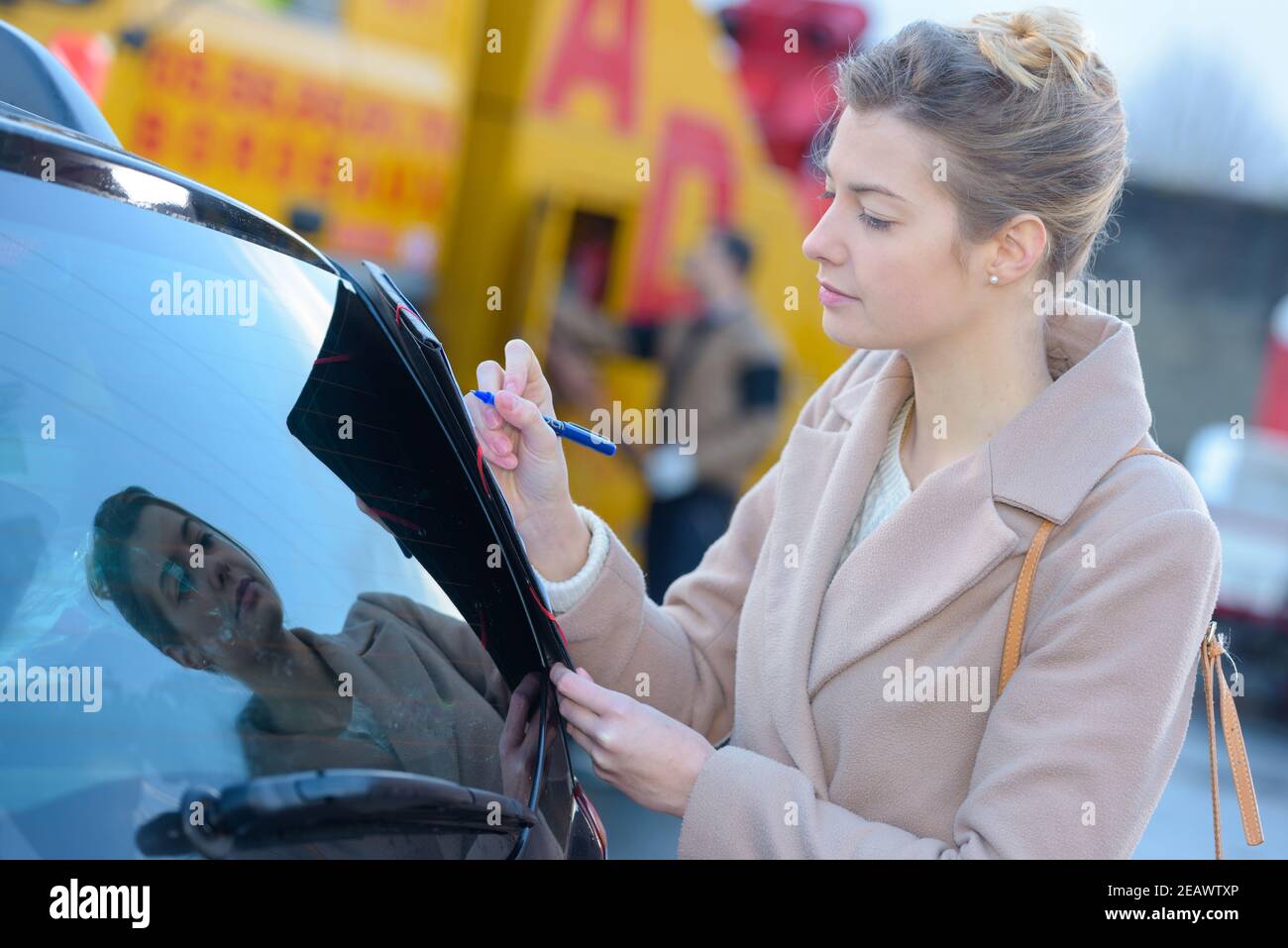 woman signing car tow paperwork Stock Photo - Alamy