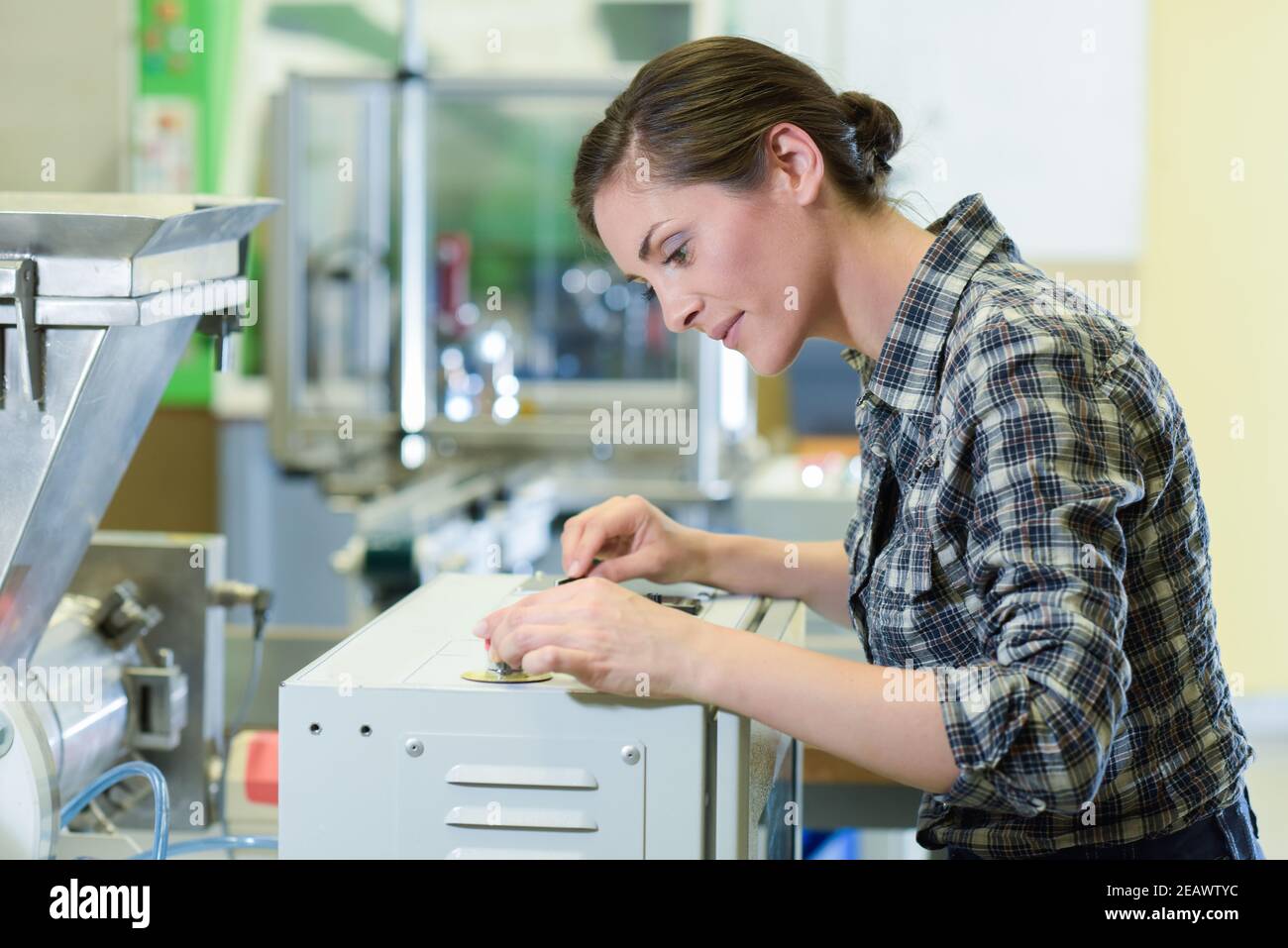 female operative using machinery in factory Stock Photo - Alamy