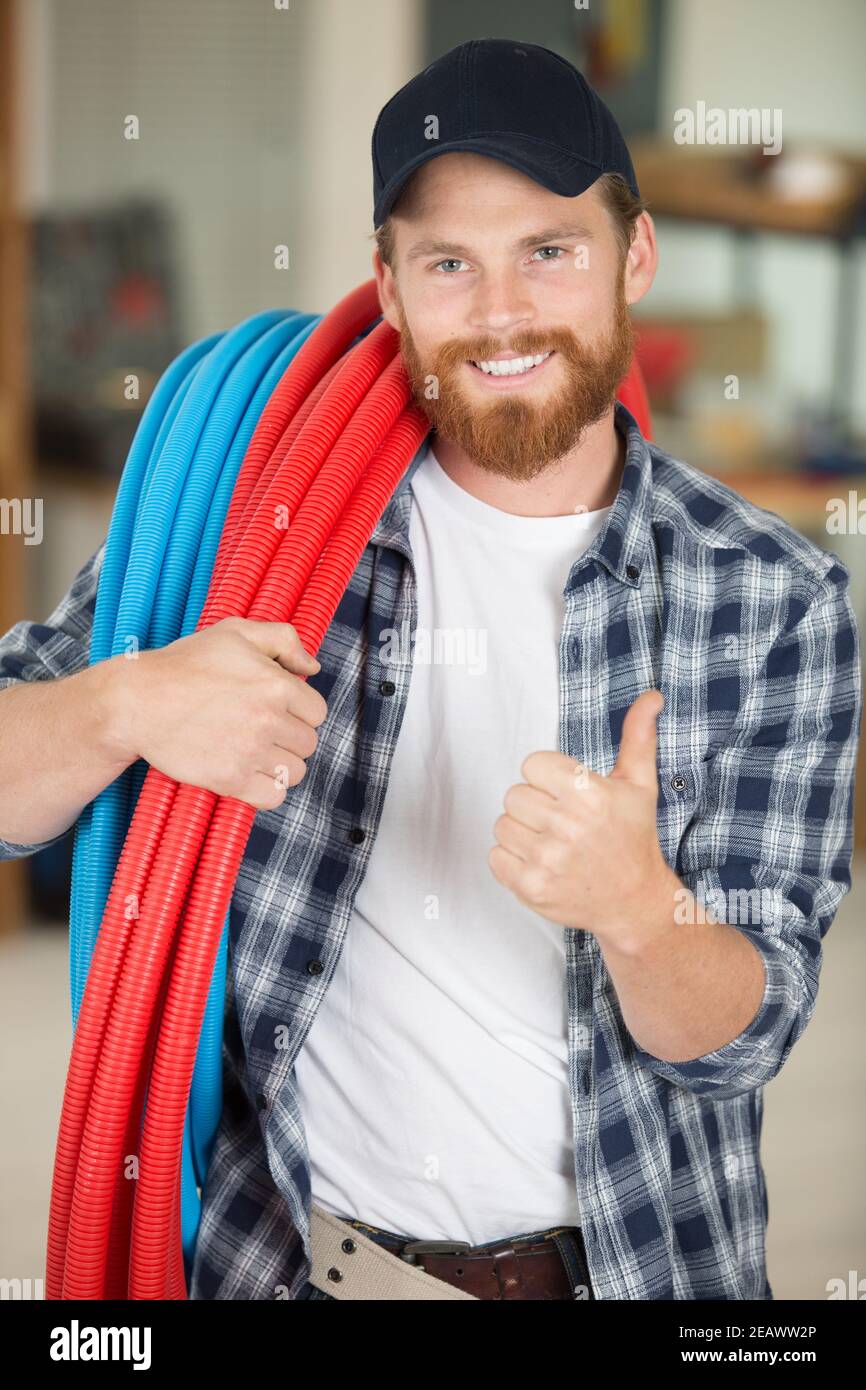 man with pipes in construction site Stock Photo - Alamy