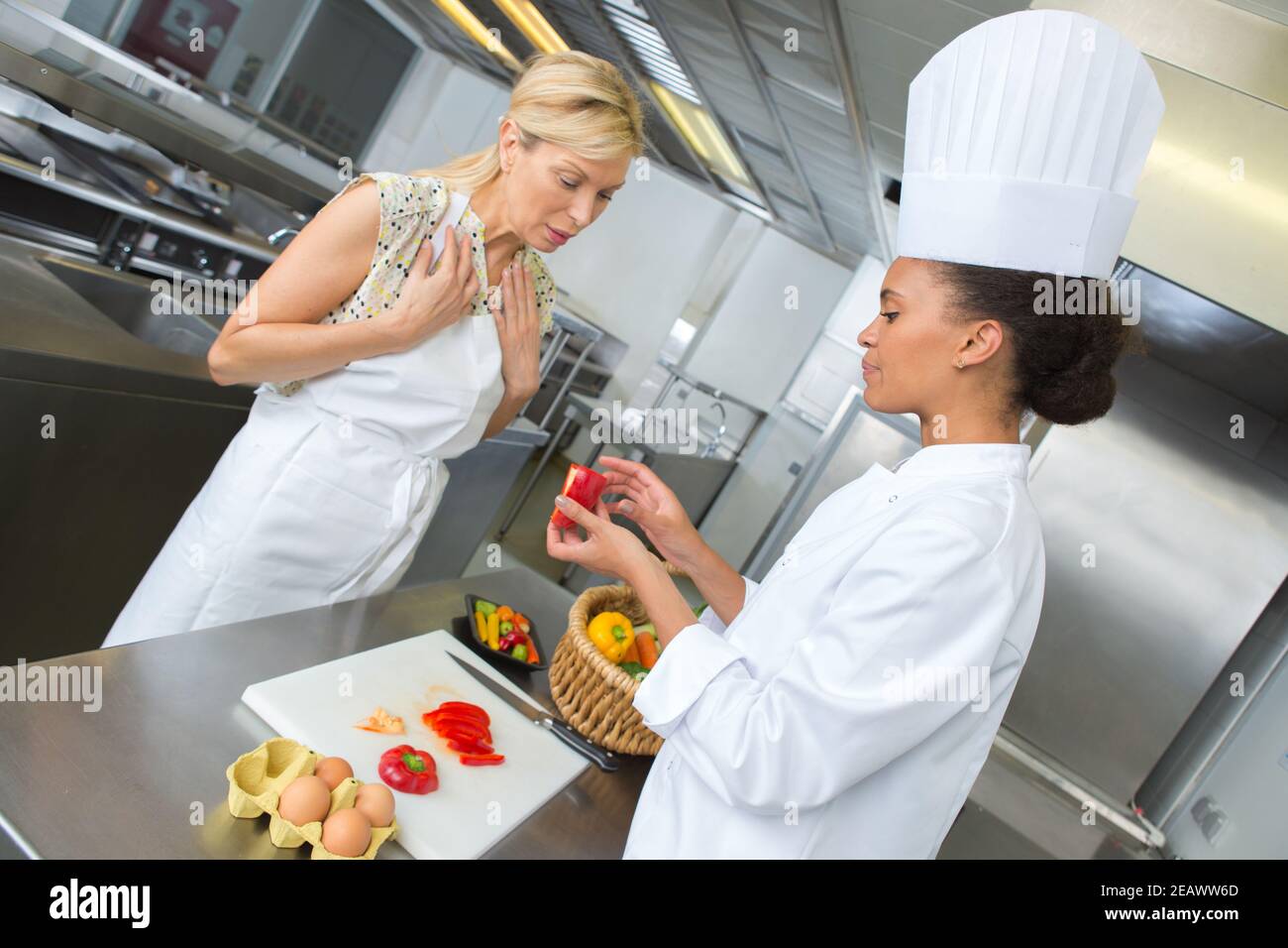 trainee chef asking question about red pepper Stock Photo - Alamy