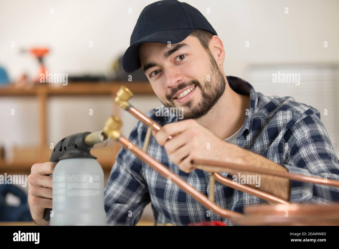 man using blowtorch on copper pipes Stock Photo - Alamy