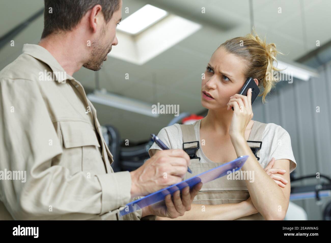 warehouse workers with smartphone working Stock Photo - Alamy