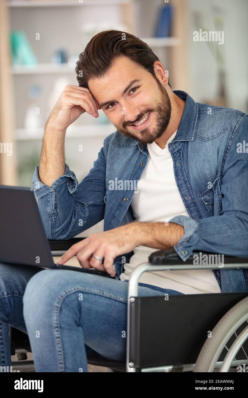 disabled man in wheelchair using laptop Stock Photo - Alamy