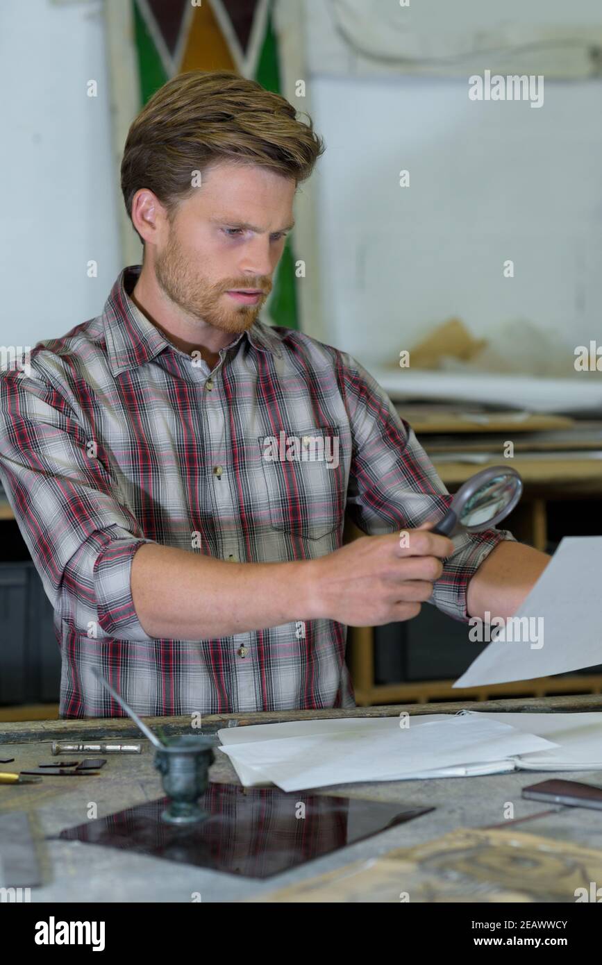 side view portrait of jeweler inspecting something Stock Photo - Alamy