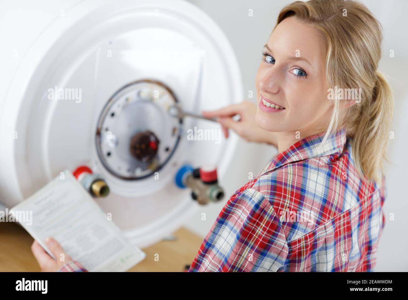 woman fixing heating system with special tool Stock Photo - Alamy