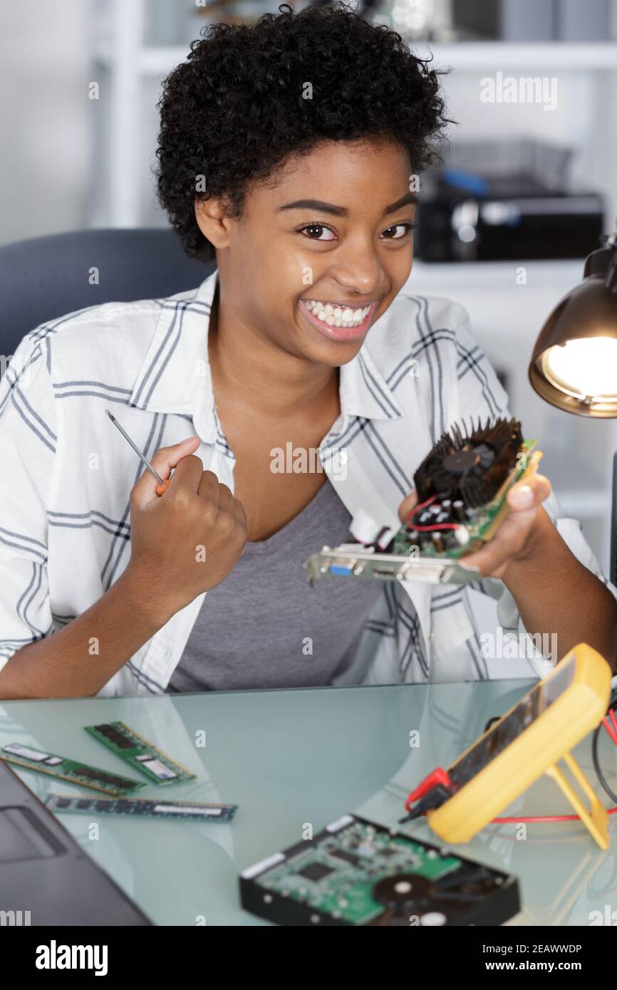 happy female pc technician checking pc parts Stock Photo - Alamy