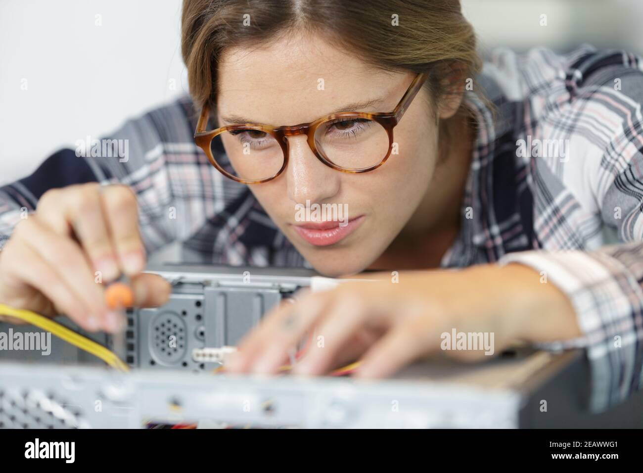 photo of woman fixing a broken pc Stock Photo - Alamy