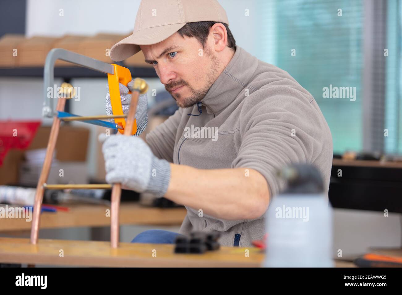 young worker clamping copper pipe Stock Photo - Alamy