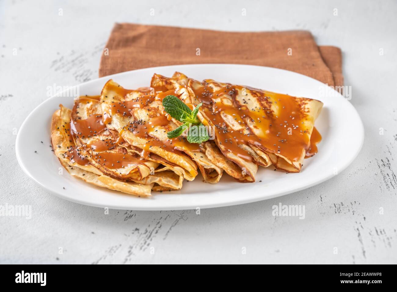 Stack of homemade crepes topped with caramel Stock Photo - Alamy