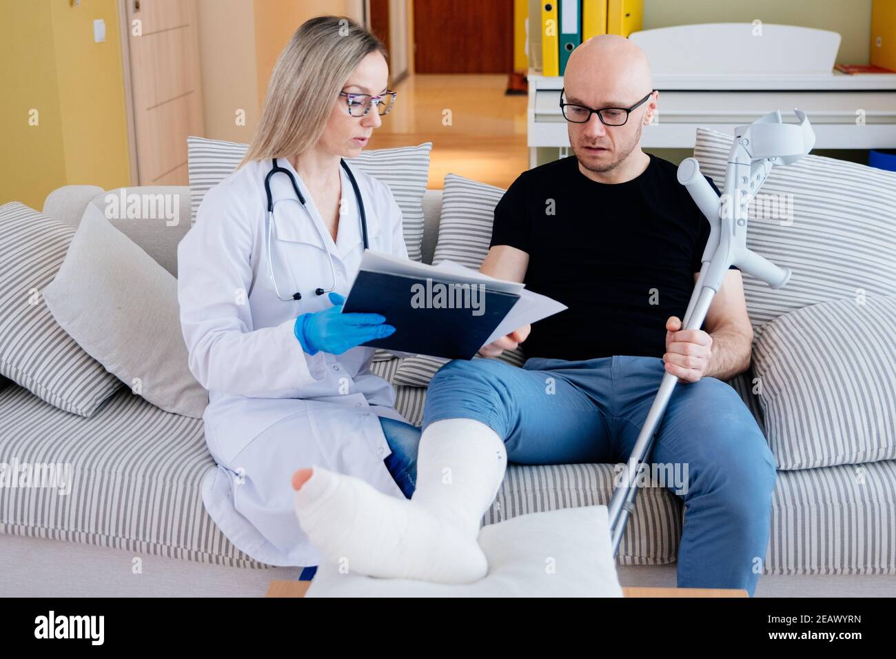 Female doctor visiting an invalid patient. Doctor and patient examining ...