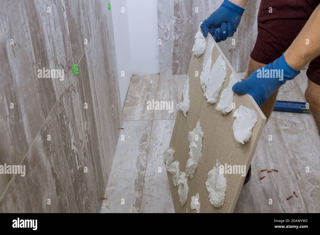 Plaster repair work laying tile, trowel in a man hand Stock Photo - Alamy