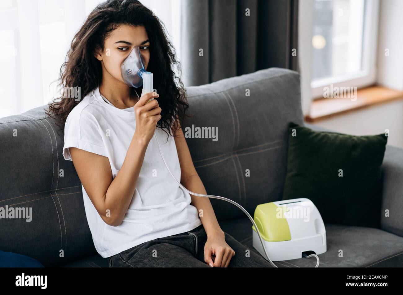 Sick african american woman with an inhaler. Unhealthy african american ...