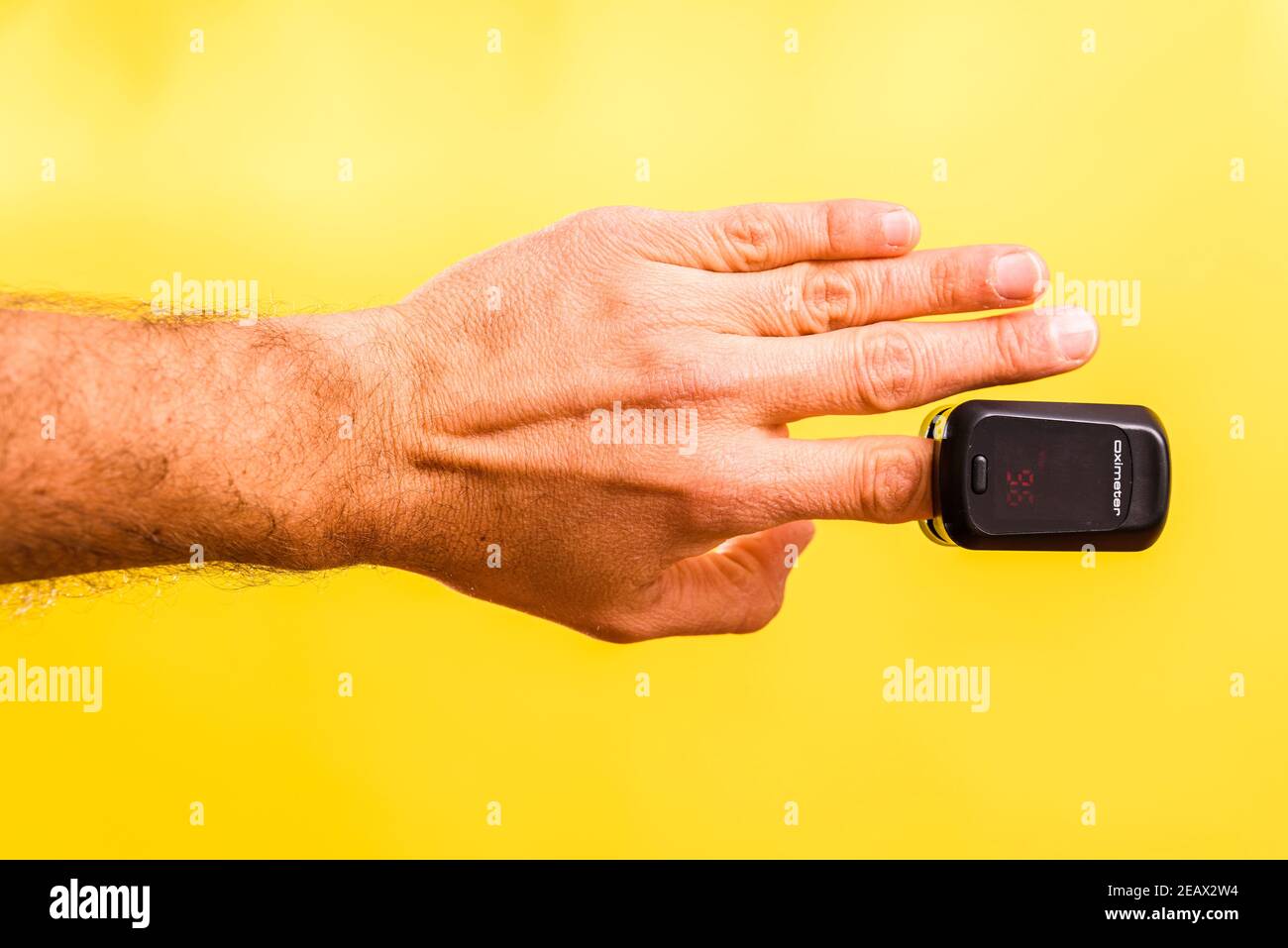 An adult is monitored for oxygen saturation and pulse with a homemade ...