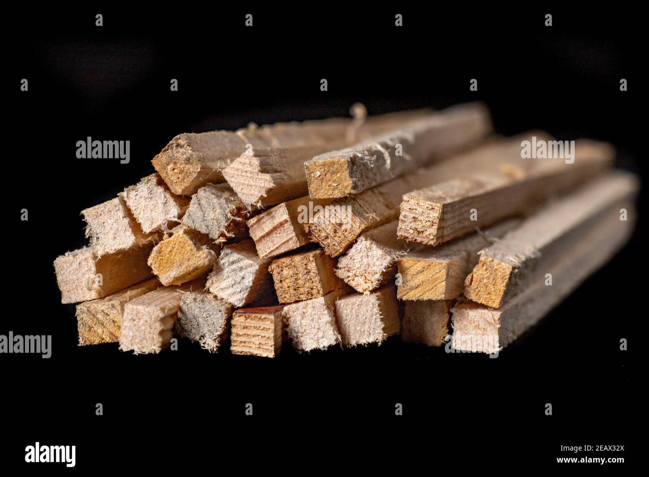 Small wooden slats with a square cross-section. Raw wood for use in a ...
