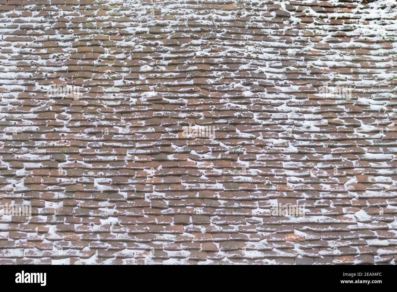 Background of red tiles covered in snow Stock Photo - Alamy