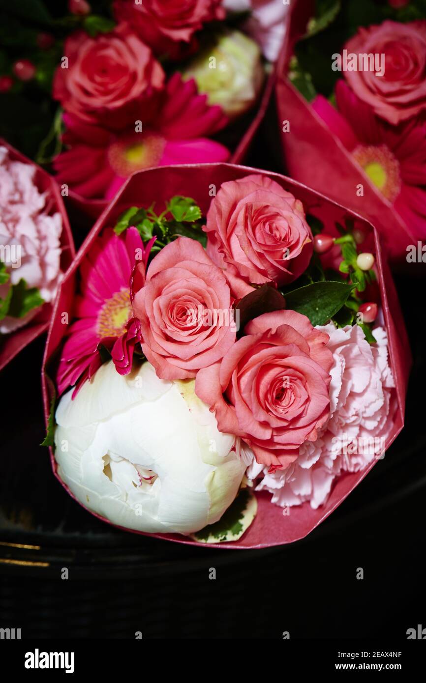 Vertical top view of pink toned delicate bouquets with fresh flower ...