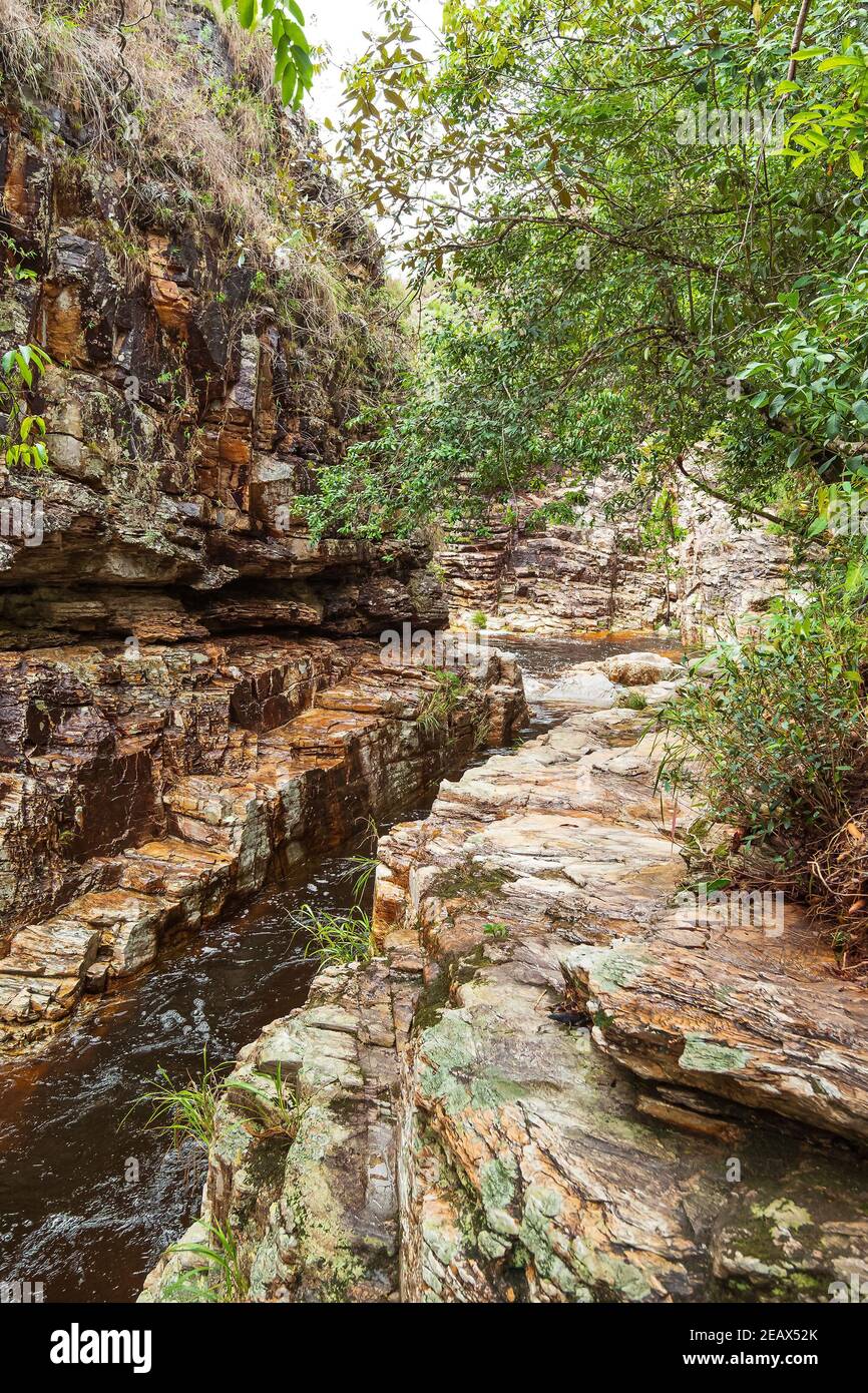 Sedimentary rock wall with a river passing by the rocks, eco tourism ...