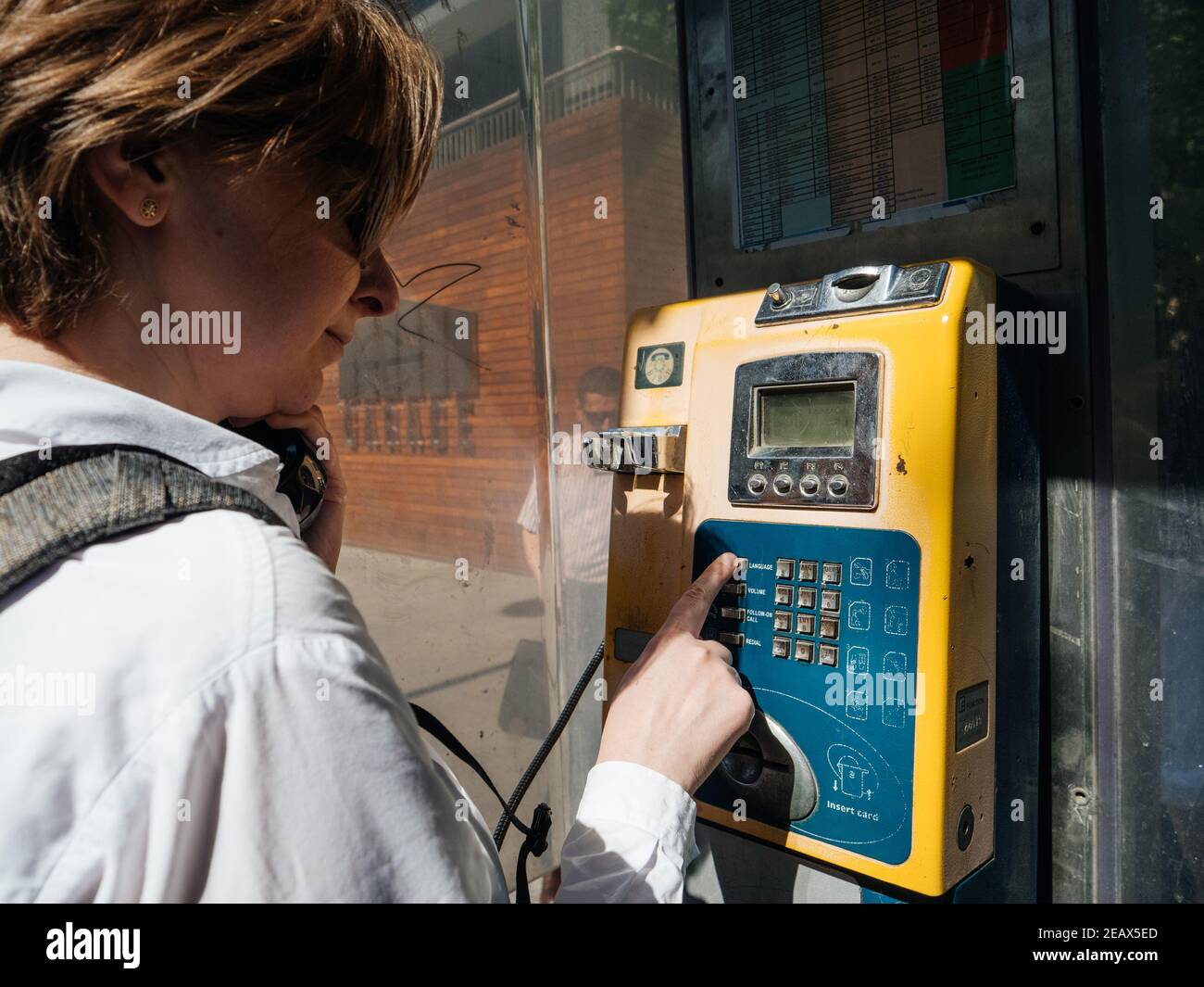 Baku Azerbaijan - May 2, 2019: Young woman using coin phone on the ...