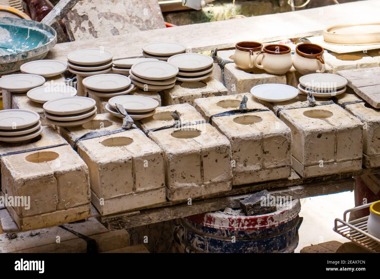 Clay injection molding technique in a traditional ceramics factory at ...