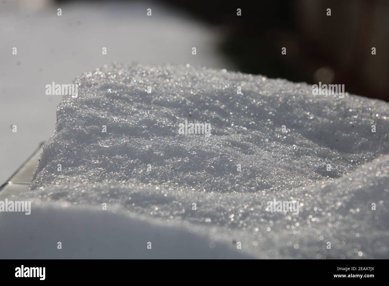 Snow on elevated surface, with blurred snow in background Stock Photo ...