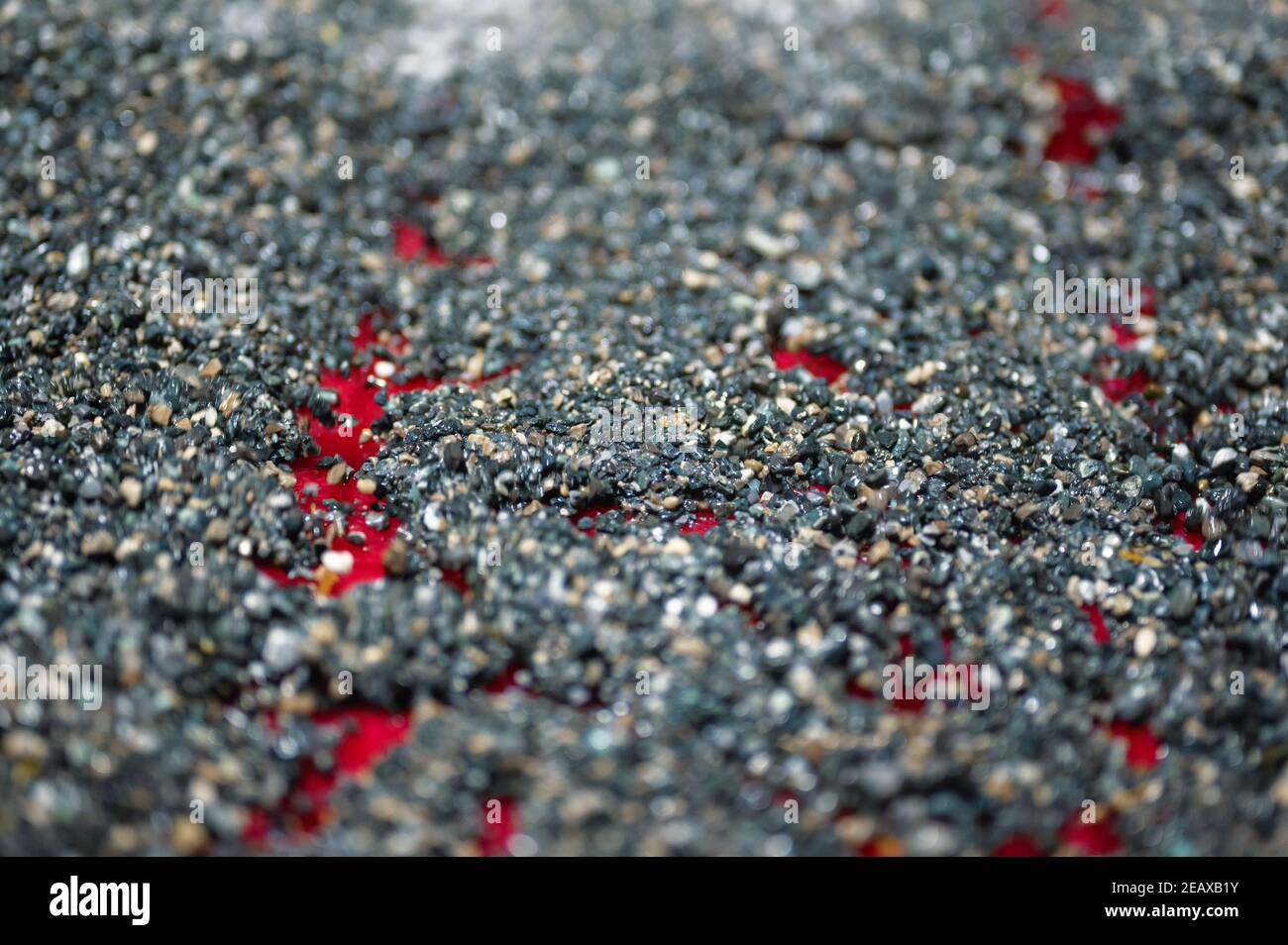 Vibrating screen, ore washing with liquid. Lots of small stones on the ...